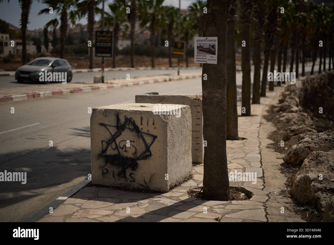 Concrete blocks set up by Israeli authorities are seen next to a gate ...