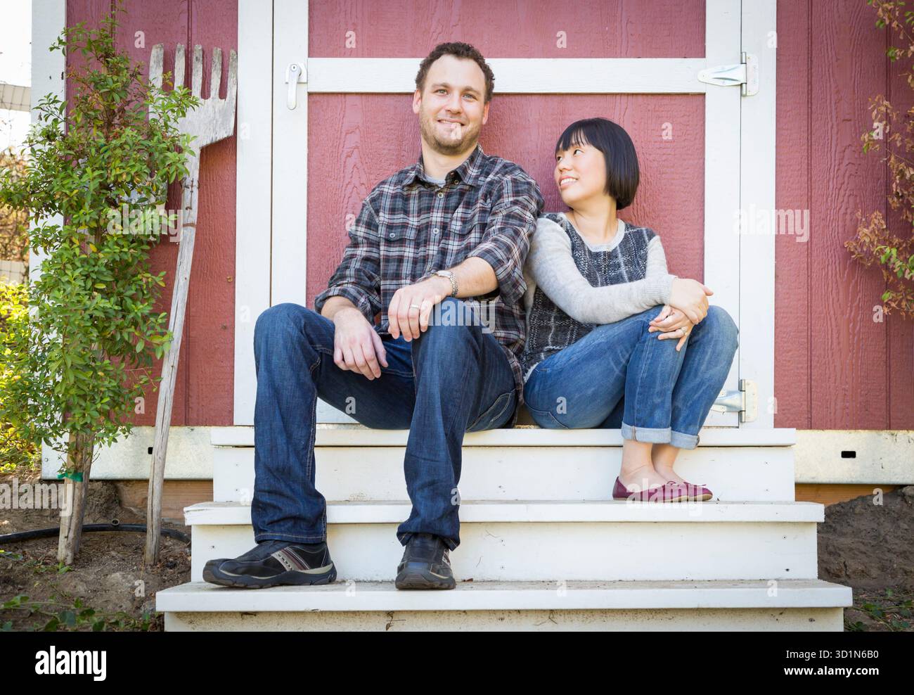 Mixed Race Couple Relaxing on the Steps Stock Photo - Alamy
