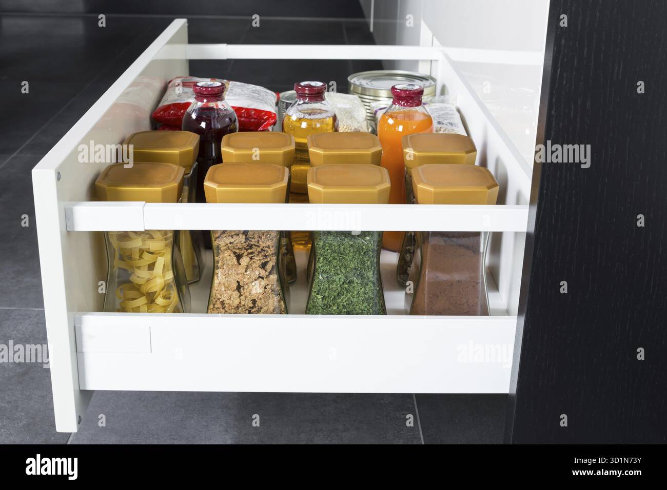 Modern kitchen countertop with food ingredients. Top view of drawers ...