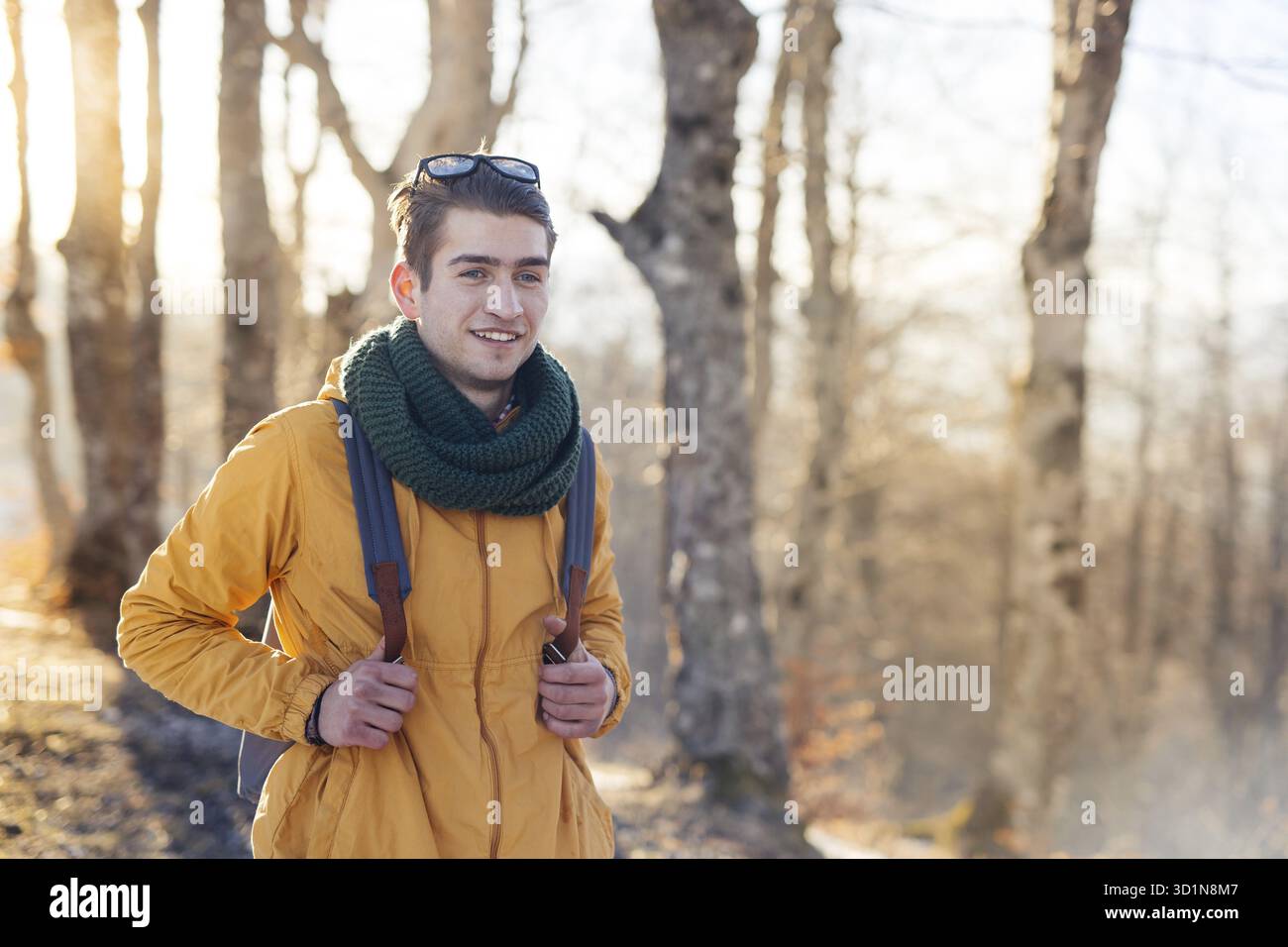 Young man standing in the forest and exploring, freedom and nature ...