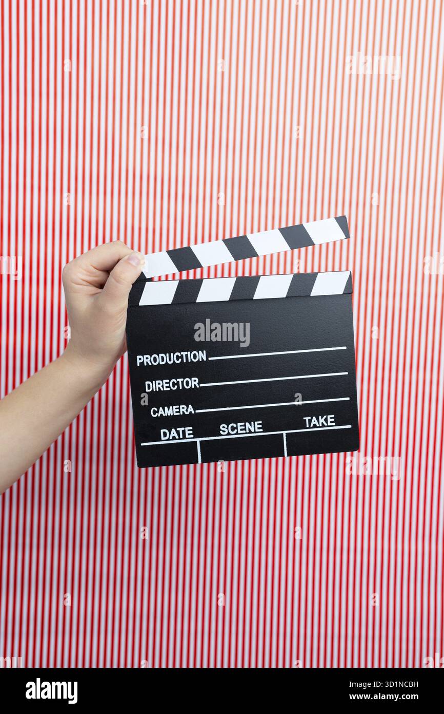 Movie marker or clapper board set against a colorfull background ...