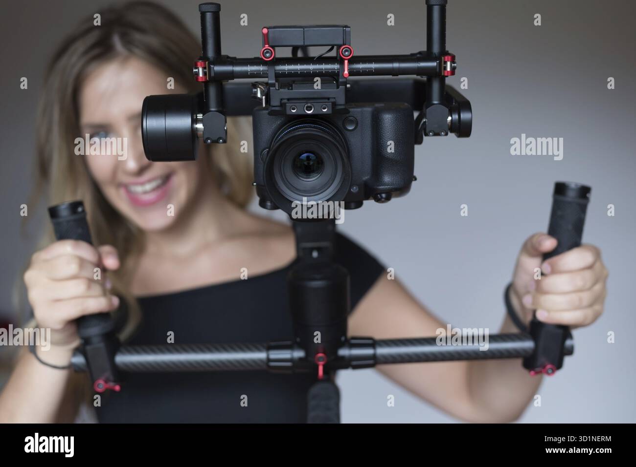 Woman videographer with gimball video slr Stock Photo - Alamy