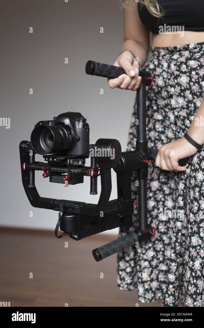 Woman videographer with gimball video slr Stock Photo - Alamy