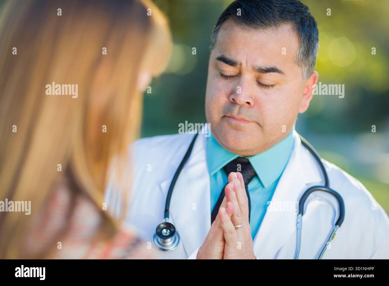 Religious doctor praying in hi-res stock photography and images - Alamy
