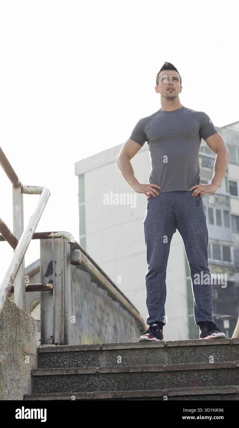 Portrait of a strong fit men dressed in sportswear jogging on the ...
