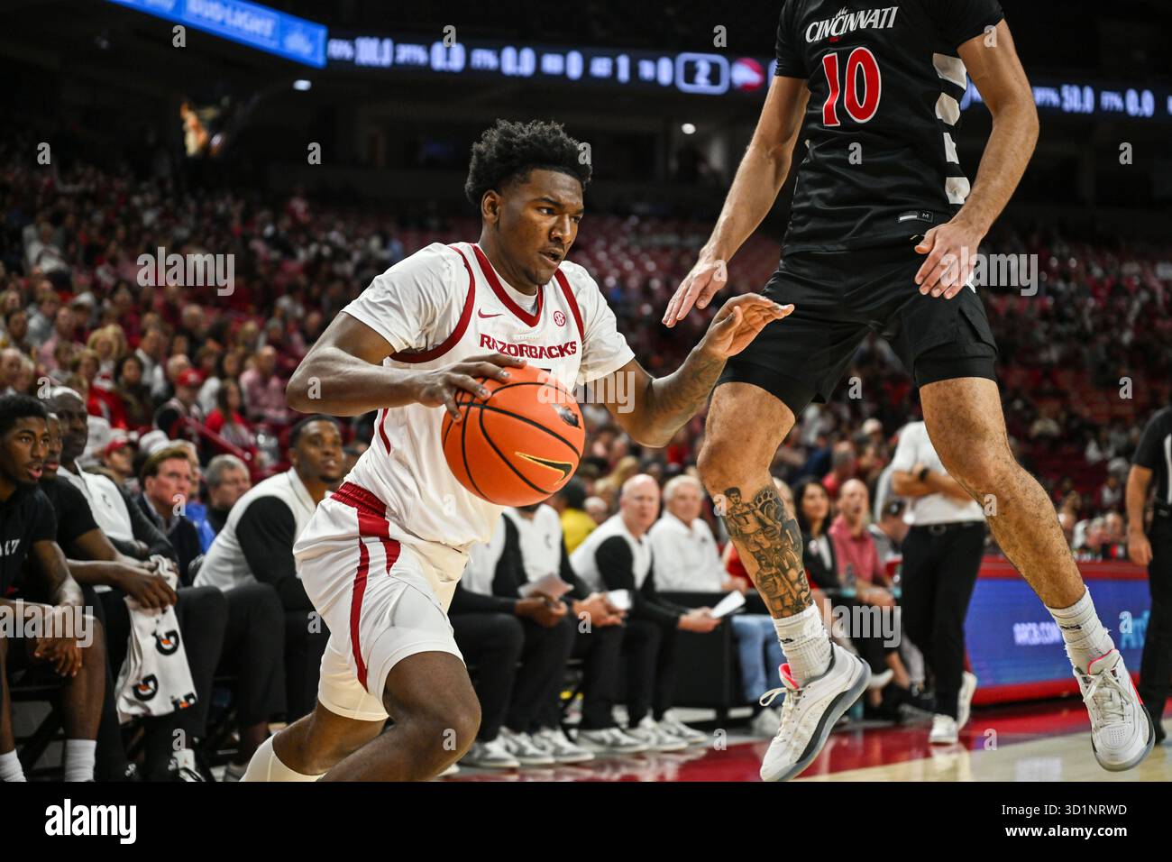 Arkansas guard Karter Knox (11) drives past Cincinnati guard Shon Abaev ...
