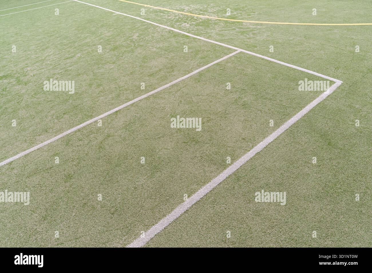 Artificial green turf with white painted lines on a open sports field ...