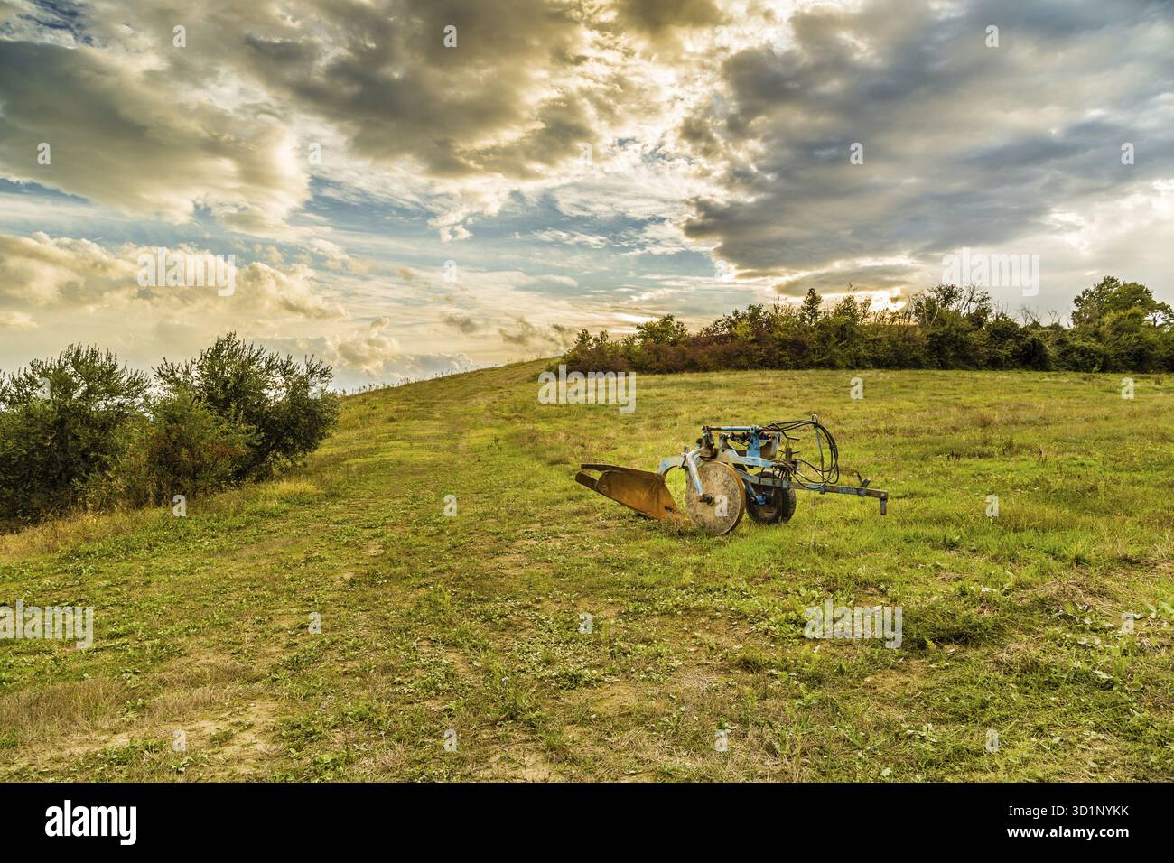 Old rusty and dirt plow left on a green but fallow hill Stock Photo - Alamy