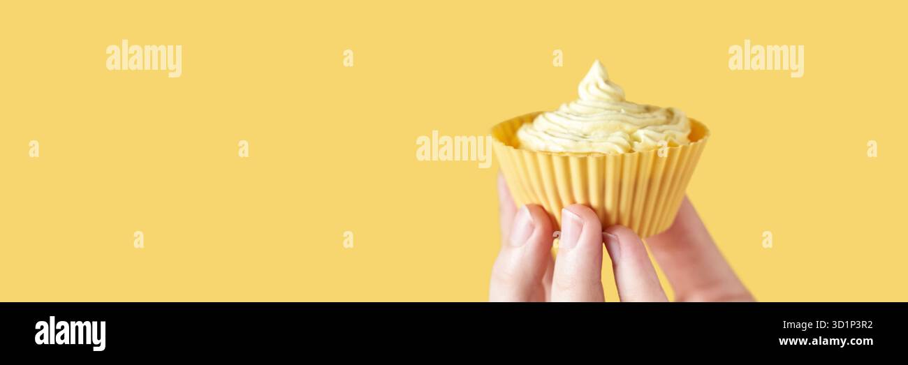 Yellow monochrome bakery. Sustainable cupcake cup. Hold in hand. Gold ...