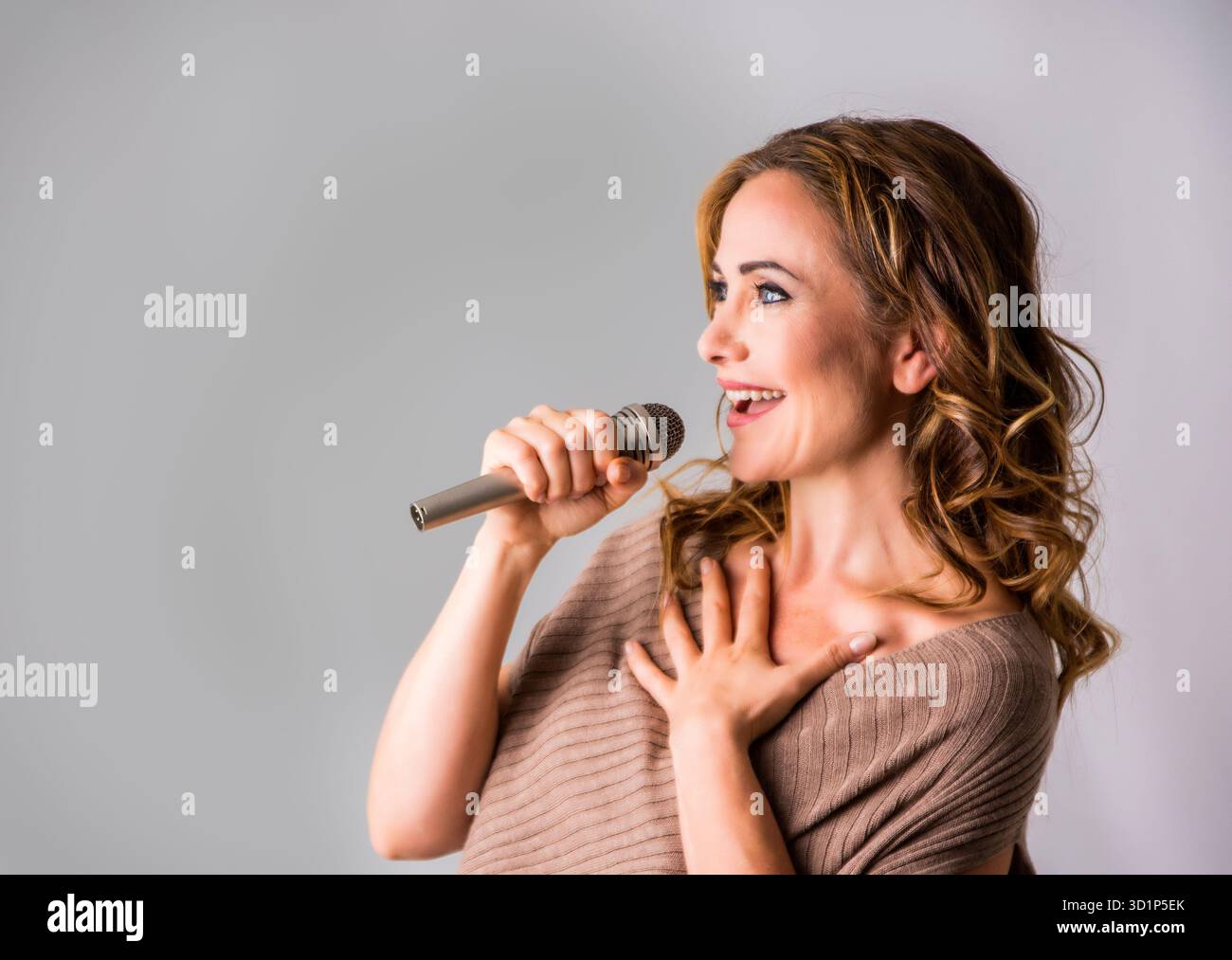 Woman speaking into microphone hi-res stock photography and images - Alamy