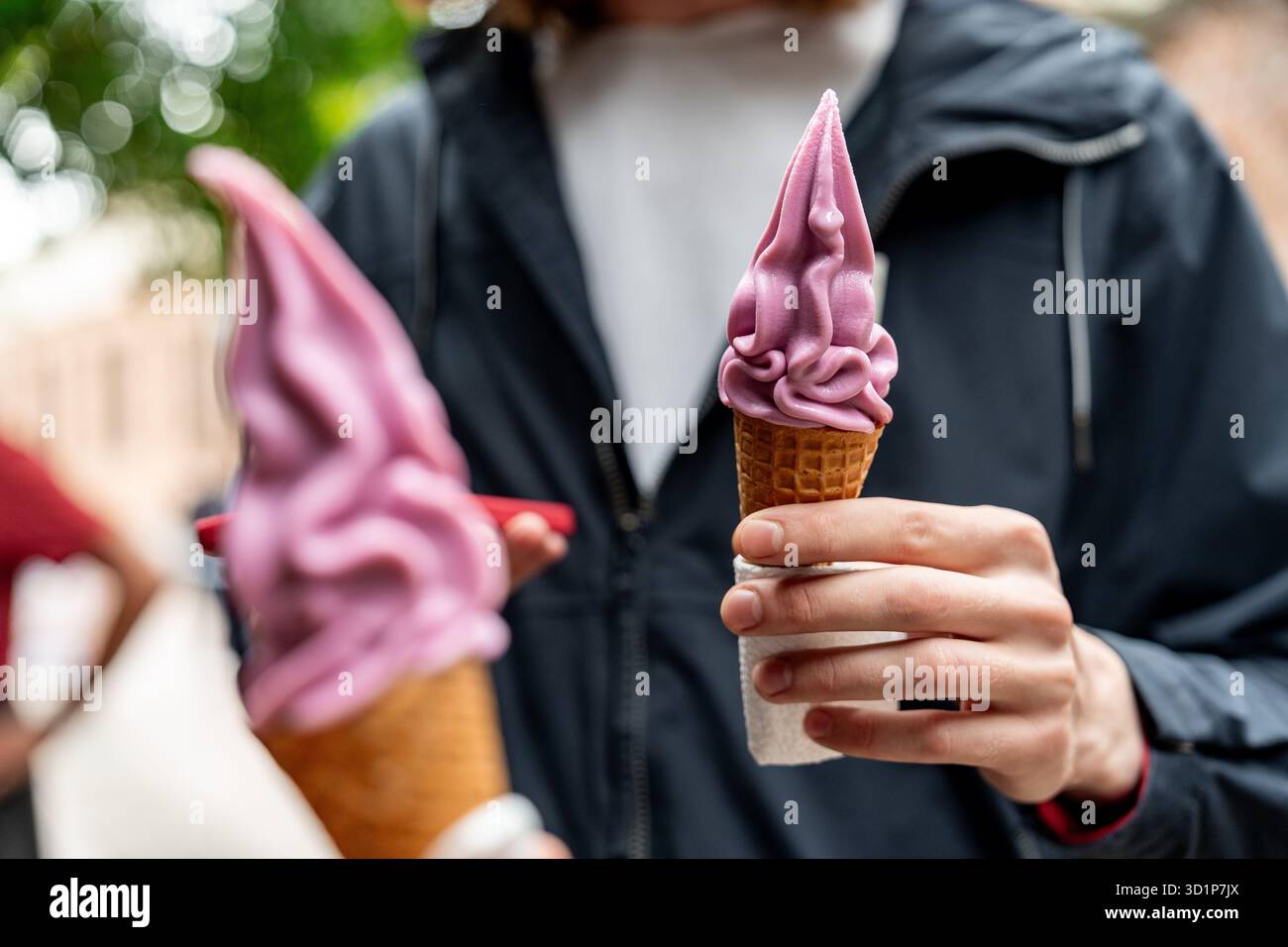 Enjoying soft serve ice cream at an outdoor location on a sunny day ...