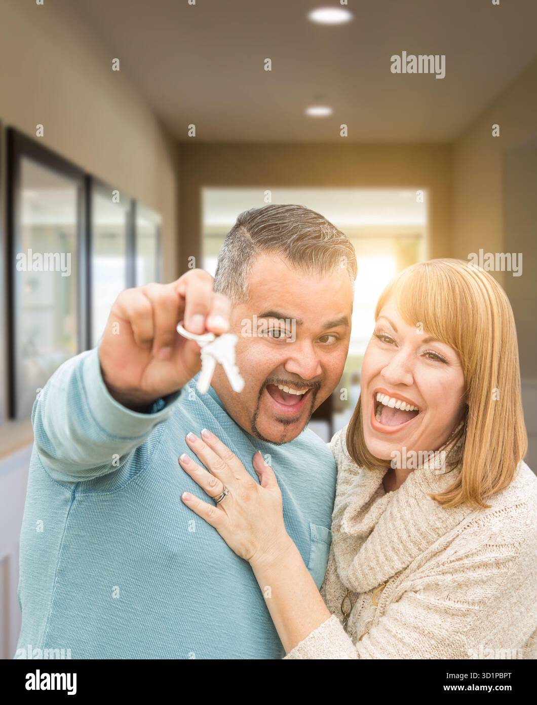 Couple Holding House Keys Inside Hallway of Their New Home Stock Photo ...