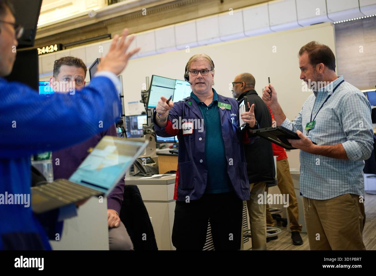 Options trader Brian Garvey, center, works on the floor at the New York ...