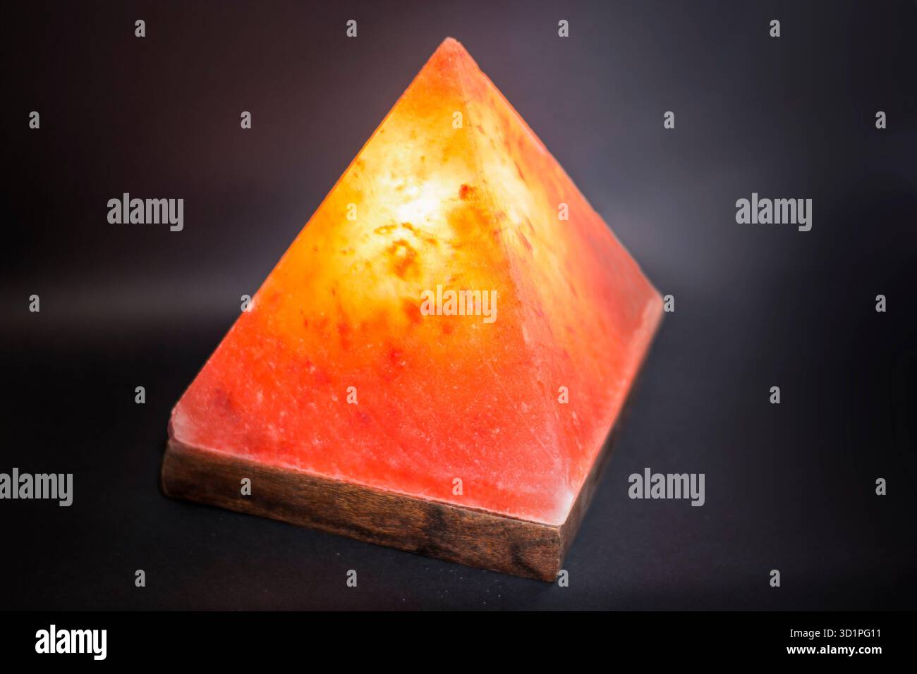 Glowing pyramid of red salt lamp Stock Photo - Alamy