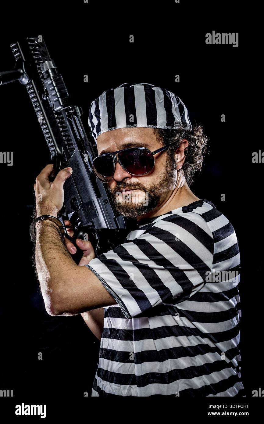 Protest .Prison riot concept. Man holding a machine gun, prisoner Stock ...