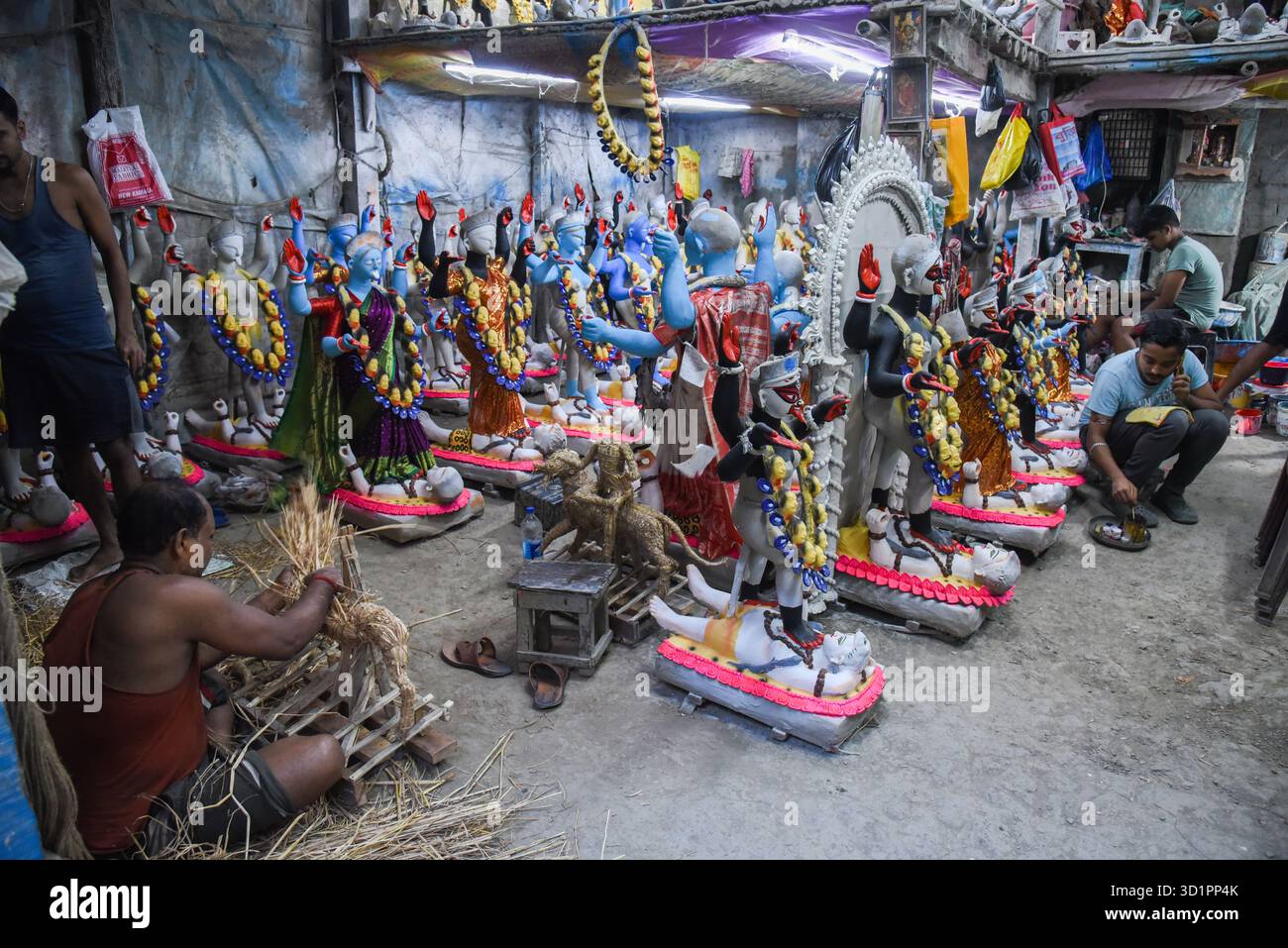 10/14/2025 An artisan gives the final touches to an idol of the Hindu ...