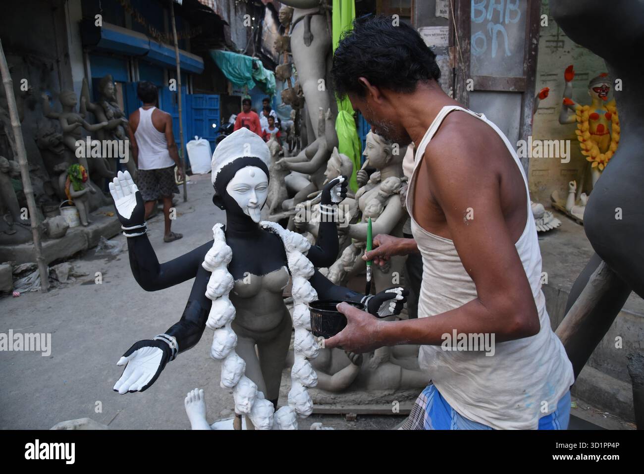 10/14/2025 An artisan gives the final touches to an idol of the Hindu ...