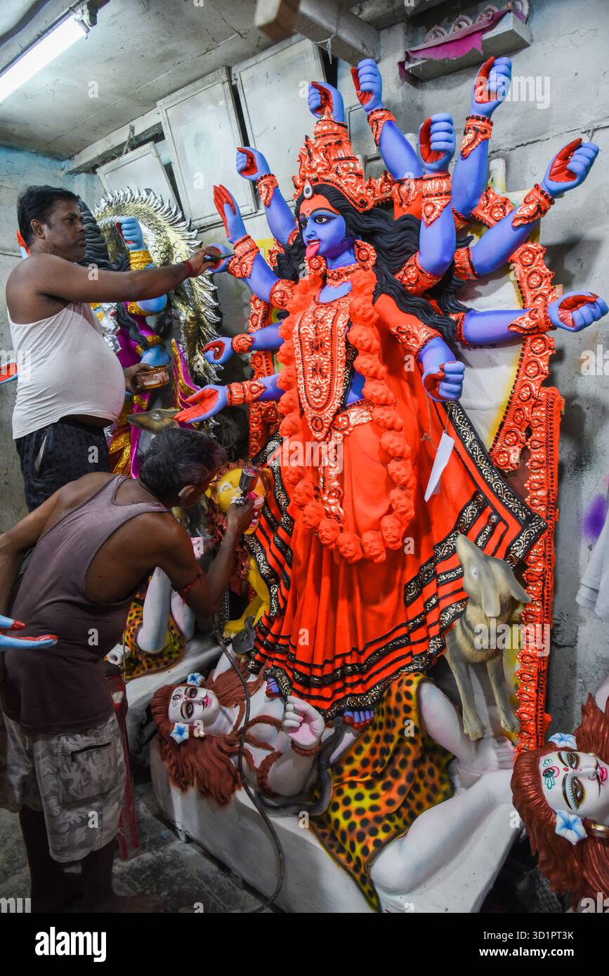 10/14/2025 An artisan gives the final touches to an idol of the Hindu ...