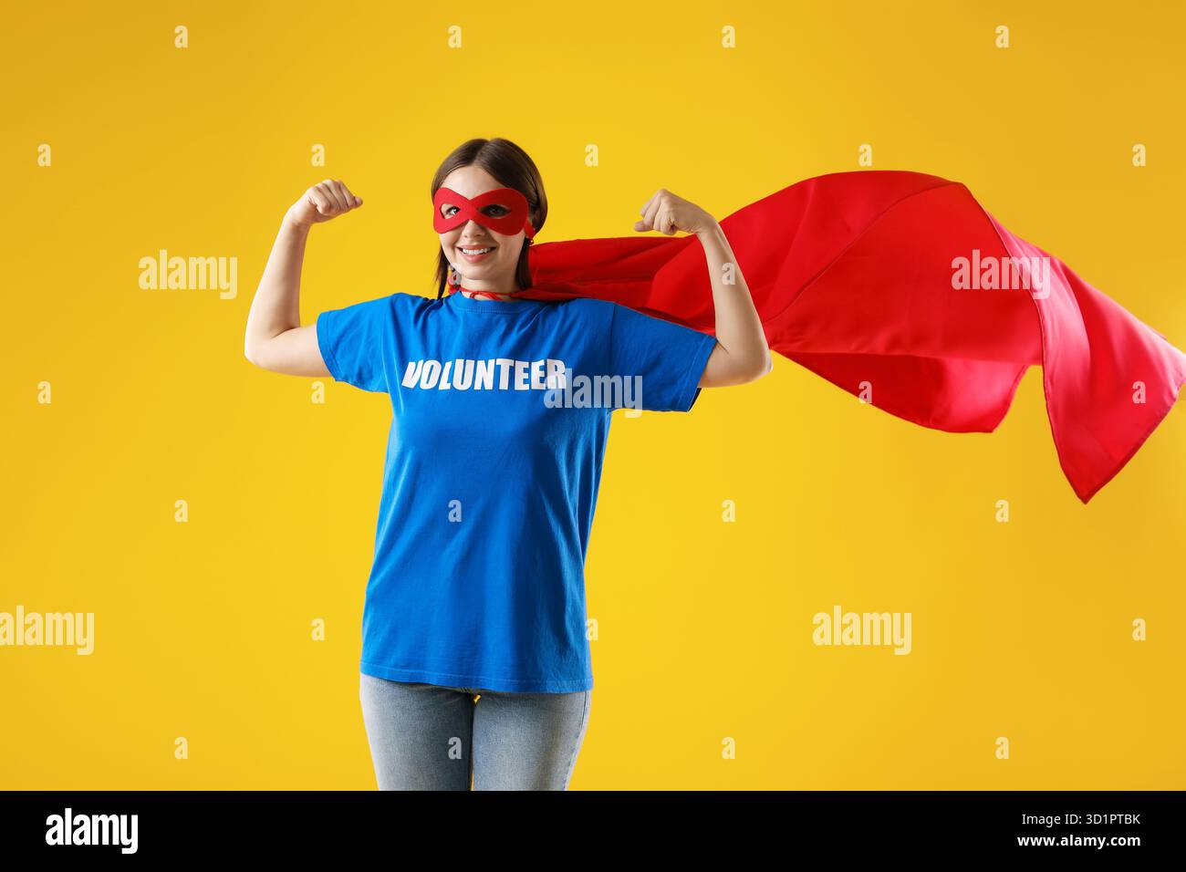 Volunteer wearing superhero costume on yellow background Stock Photo ...