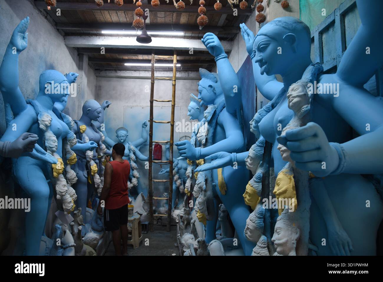 10/14/2025 An artisan gives the final touches to an idol of the Hindu ...