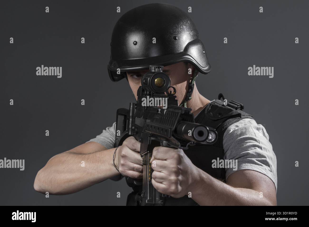 Security, paintball sport player wearing protective helmet aiming ...