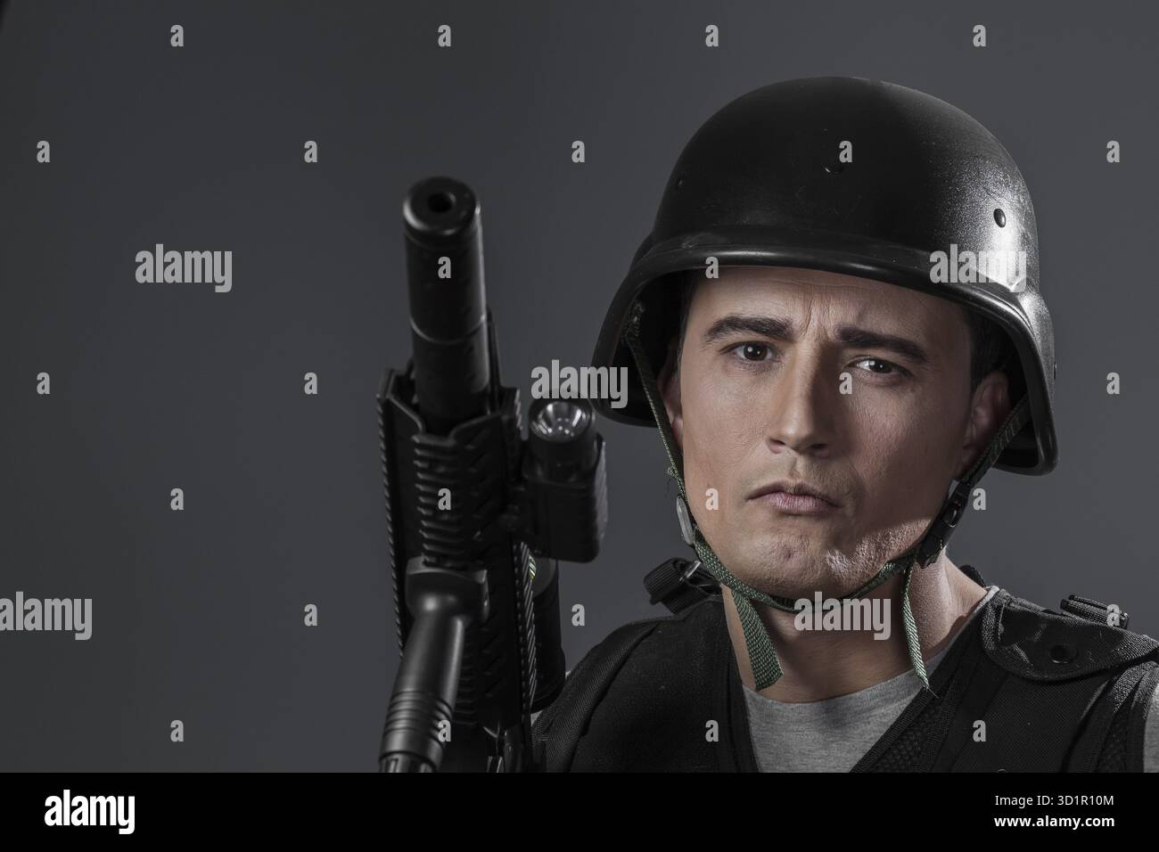 Security, paintball sport player wearing protective helmet aiming ...