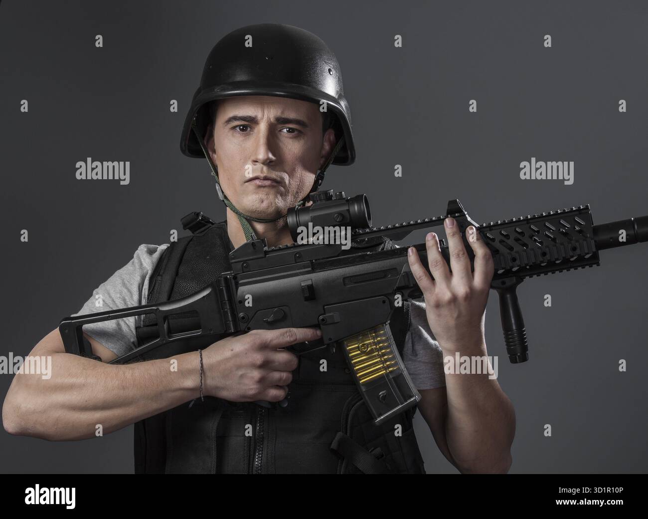 Recreation, paintball sport player wearing protective helmet aiming ...