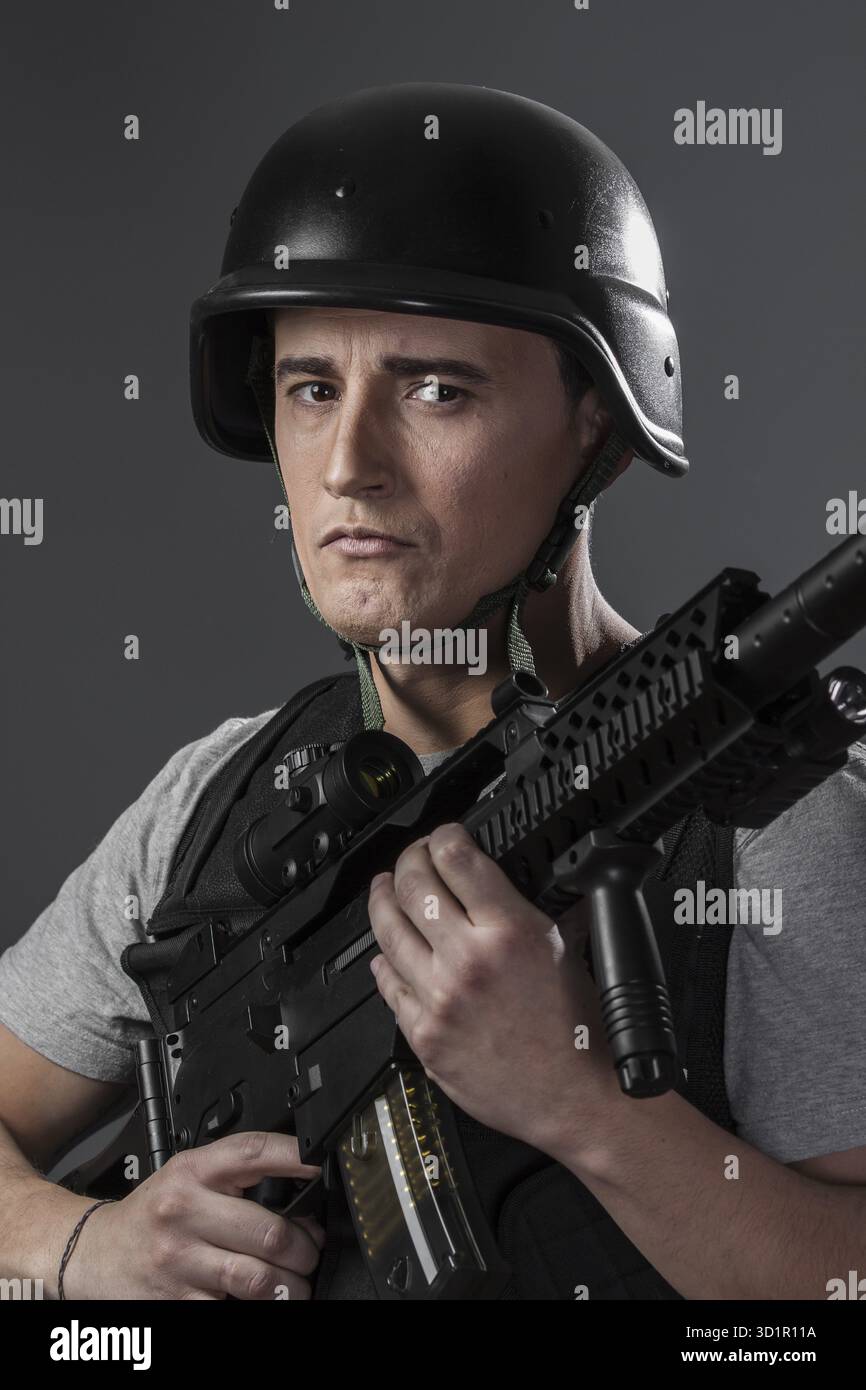Gunfire, paintball sport player wearing protective helmet aiming pistol ...