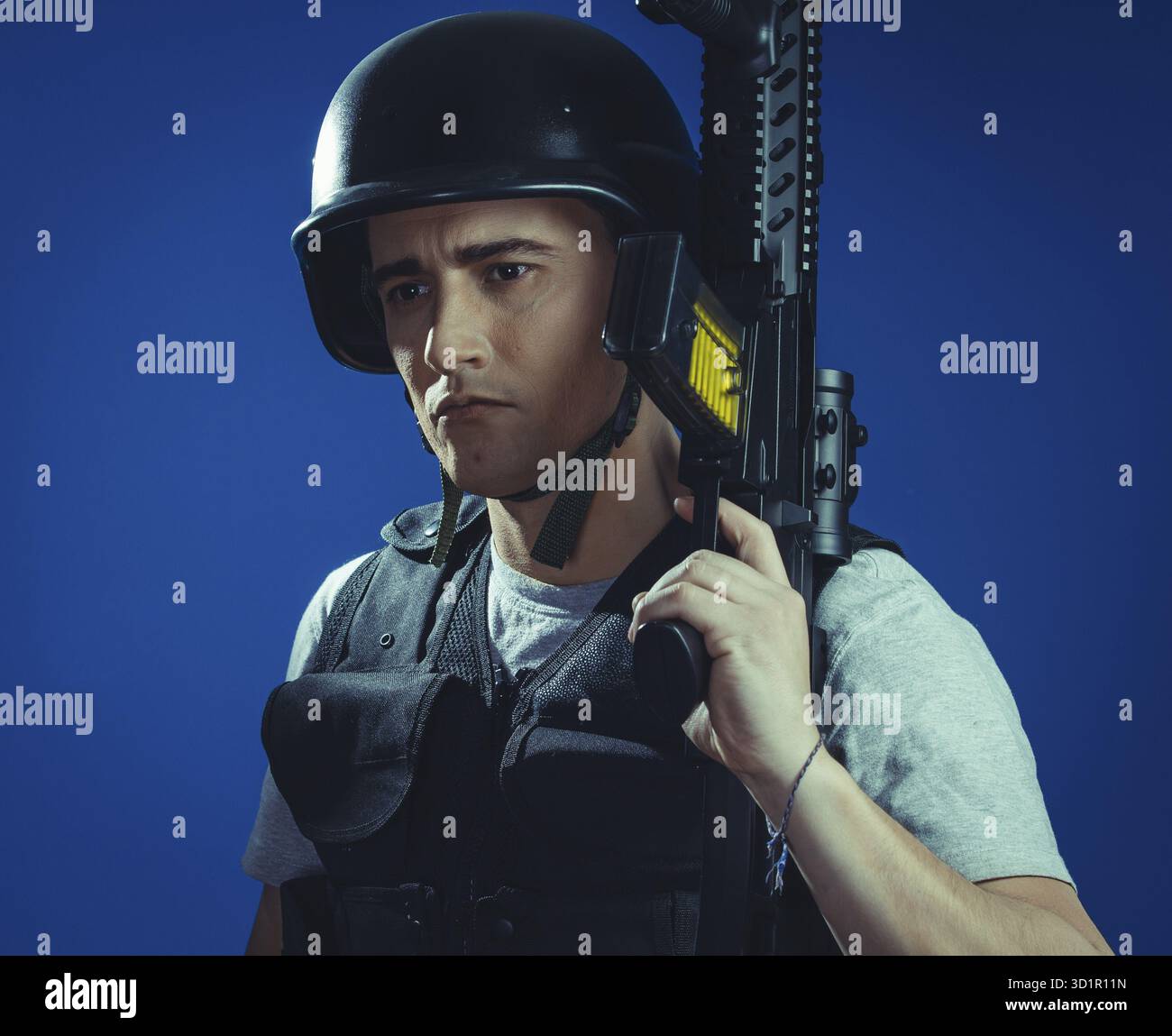 Airsoft sport player wearing protective helmet aiming pistol, black ...