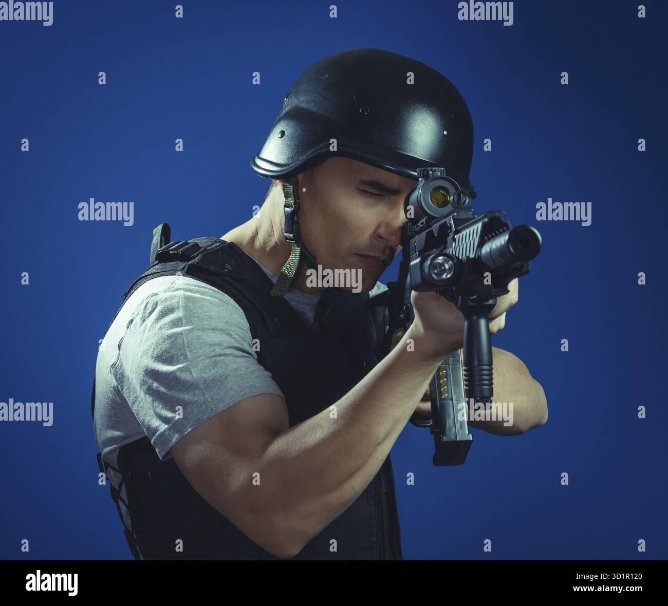 Security, paintball sport player wearing protective helmet aiming ...