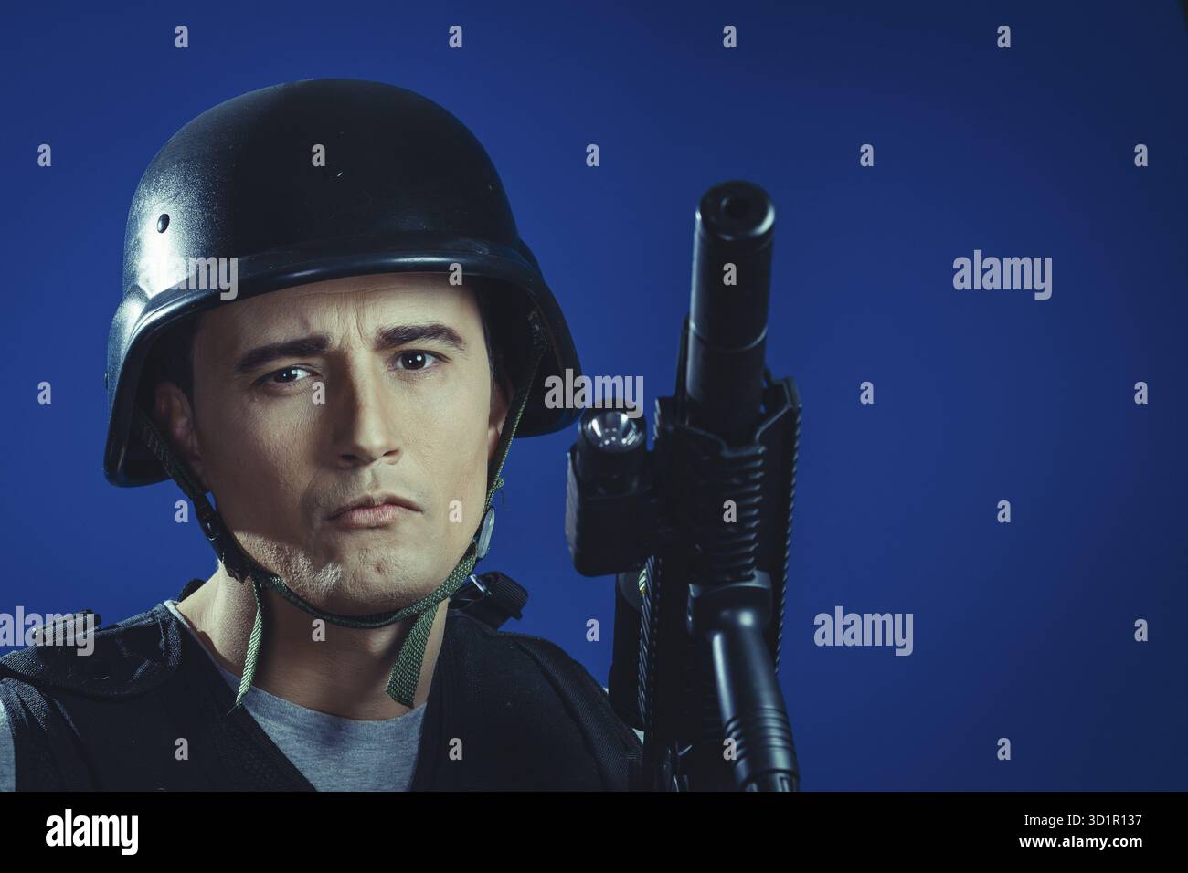 Security, paintball sport player wearing protective helmet aiming ...
