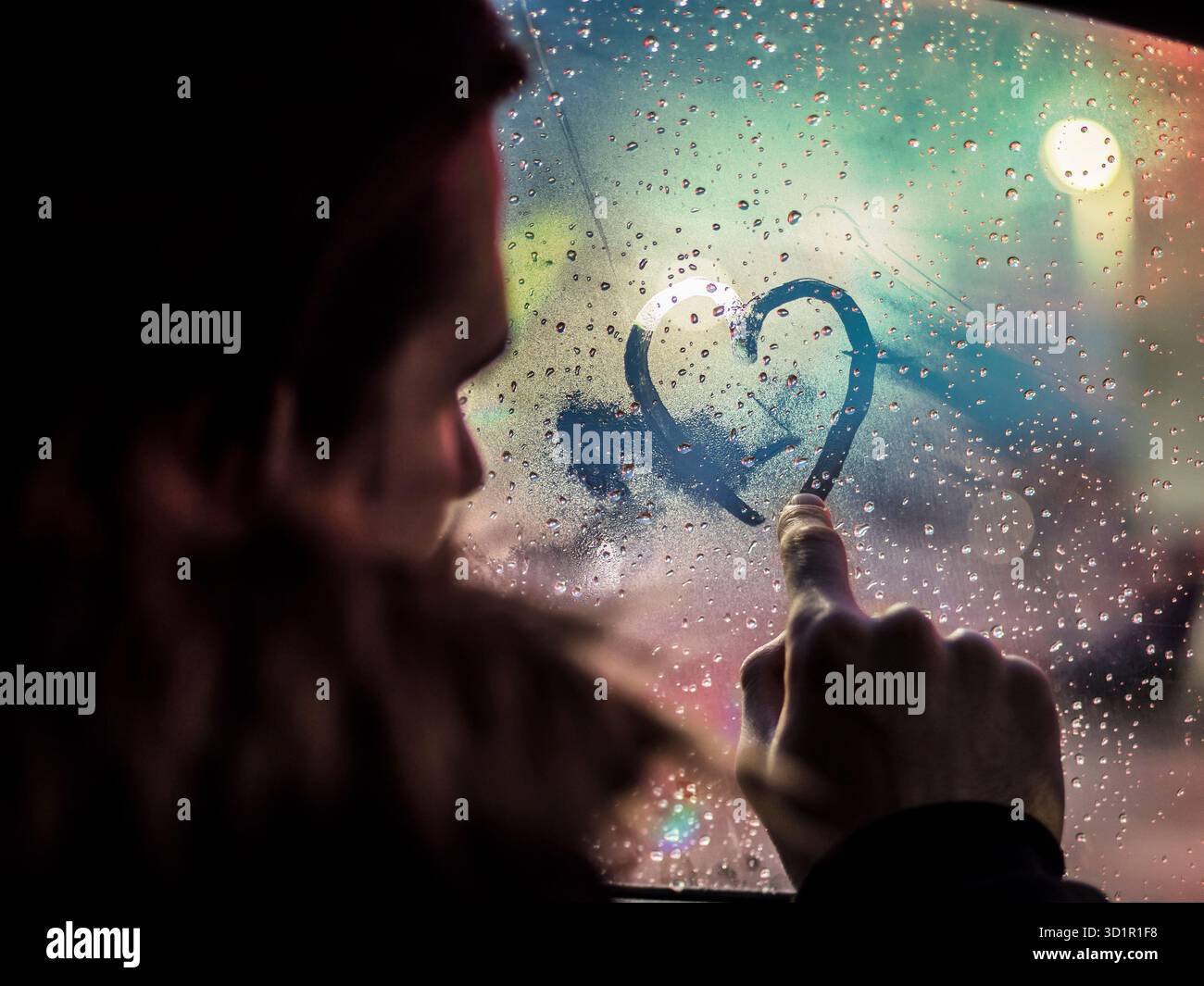 Man in love drawing heart on window Stock Photo - Alamy