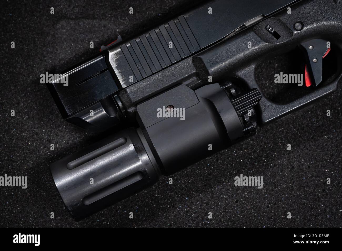 Close-up of a highly customized tactical pistol featuring a muzzle ...
