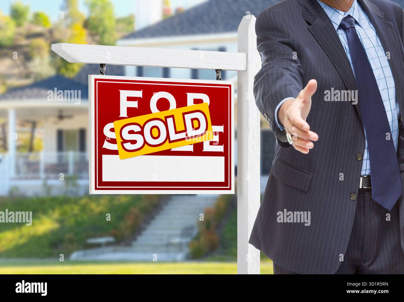 Male Agent Reaching for Hand Shake in Front of Sold For Sale Sign and ...