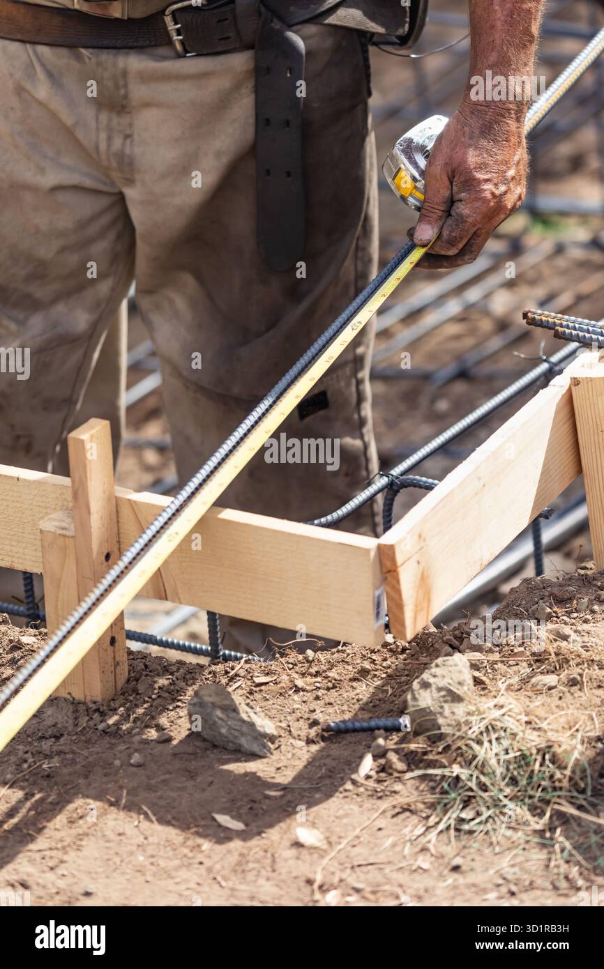 Worker Measuring Steel Rebar At Construction Site Stock Photo - Alamy