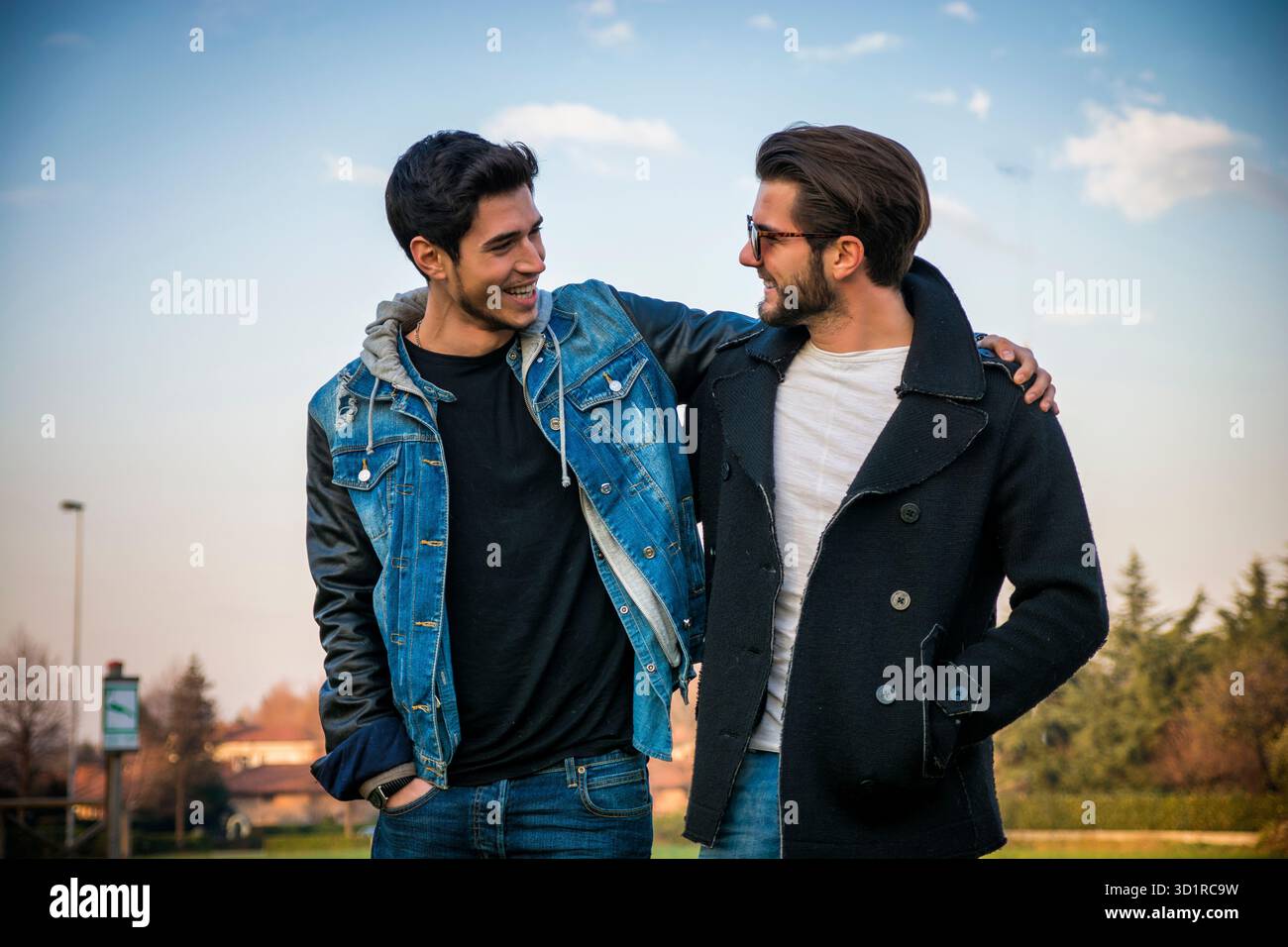 Two young people in a park talking hi-res stock photography and images ...