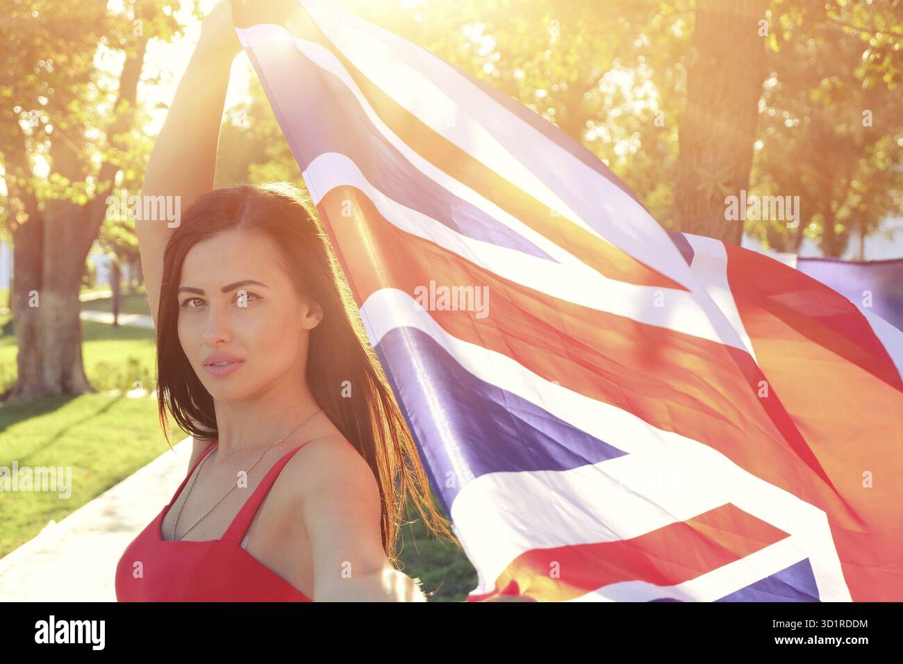 British girl holding the Jack Union flag in her hands Stock Photo - Alamy