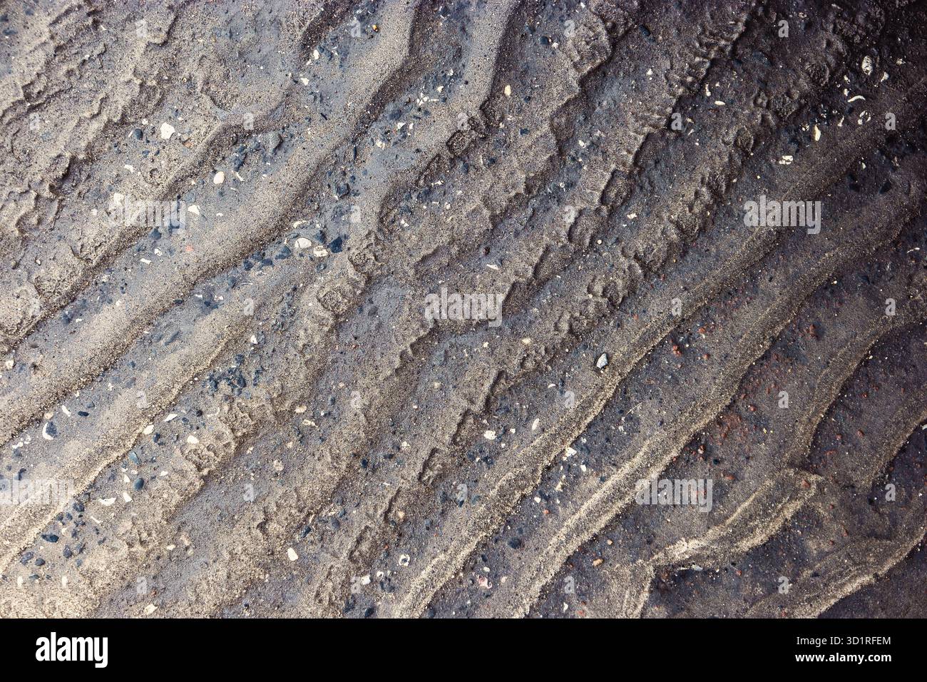 Waves pattern of sand on asphalt road after rain, dirty road texture ...
