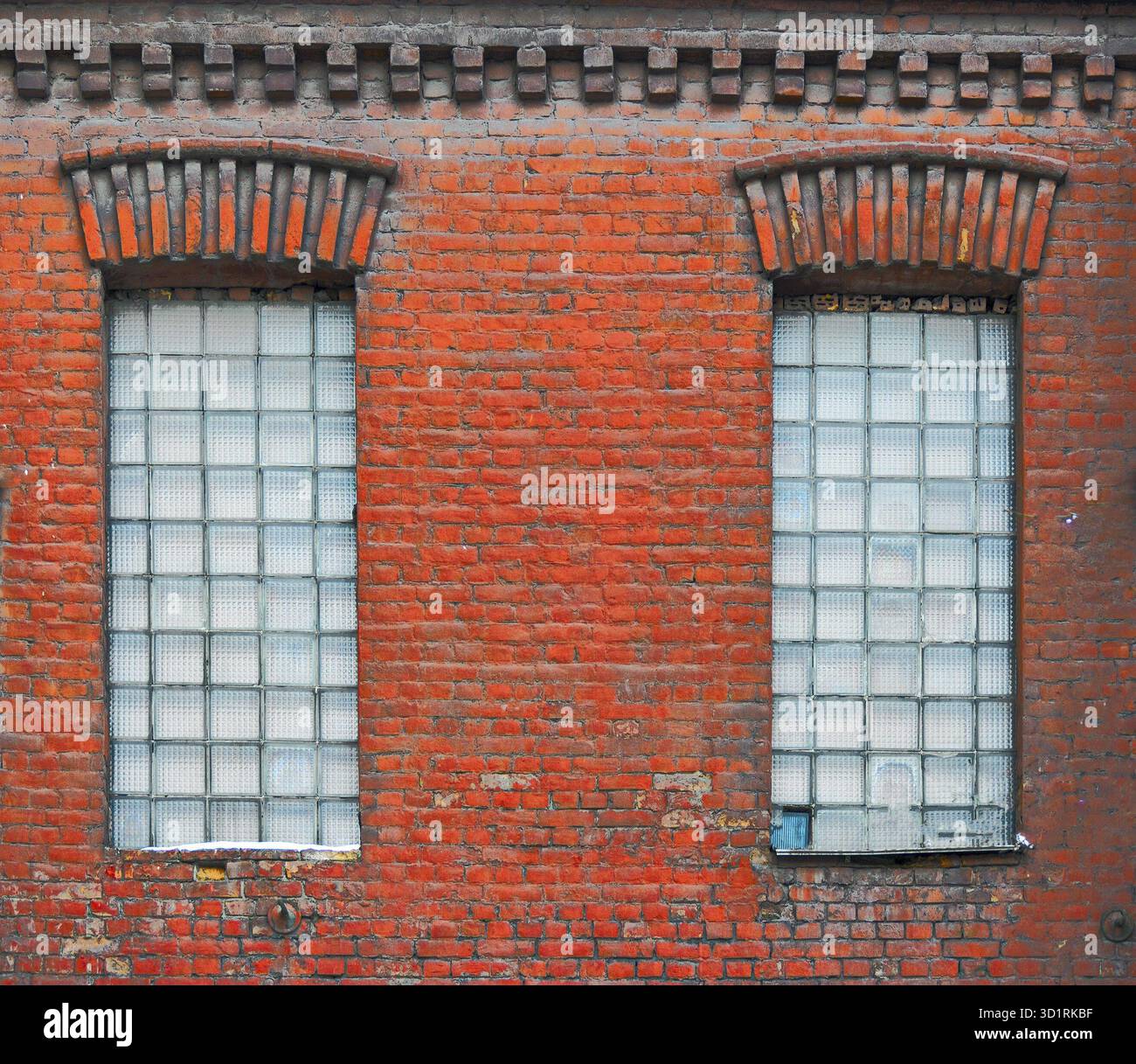 Two old windows with square glass blocks in old worn down factory ...