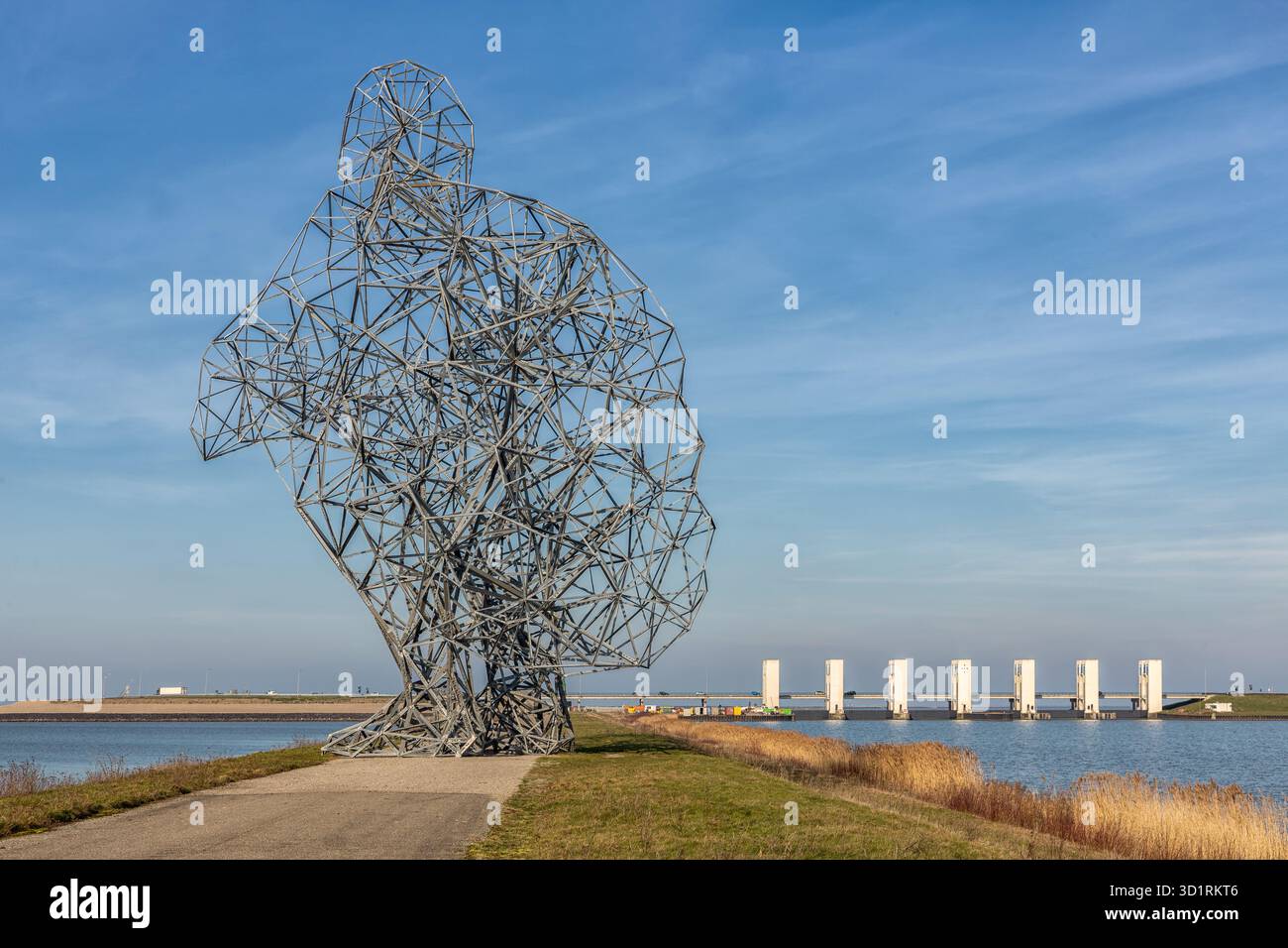 Iron statue of man on dam in Lelystad, The Netherlands Stock Photo - Alamy