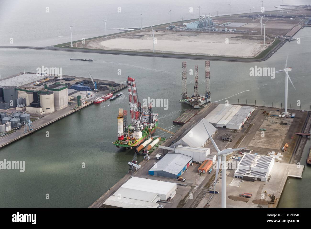 Dutch harbor Eemshaven with wind turbines and offshore construction ...