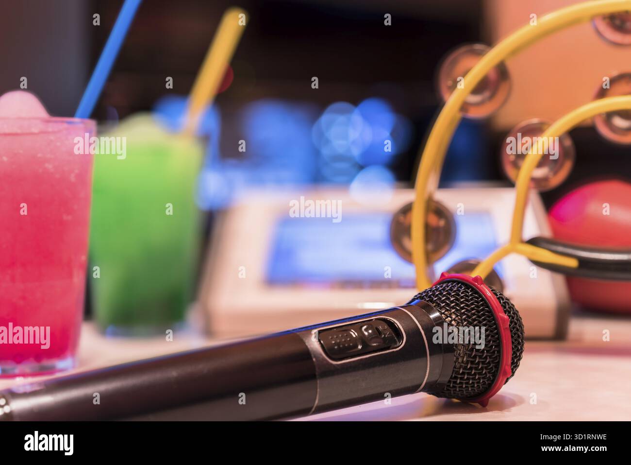Black microphone in karaoke club, with remote controller, melon and ...