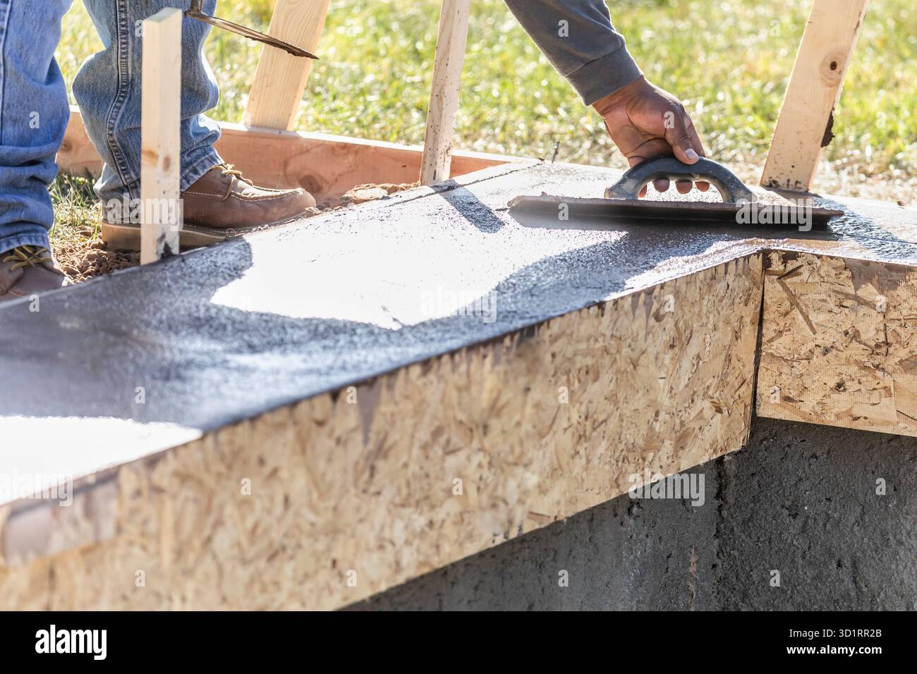 Construction Worker Using Wood Trowel On Wet Cement Forming Coping ...