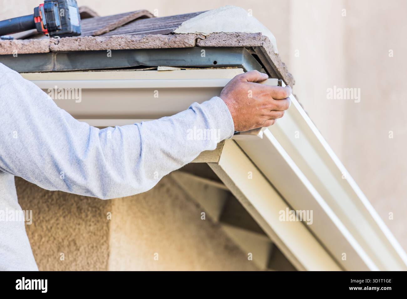 Worker Attaching Aluminum Rain Gutter to Fascia of House Stock Photo ...