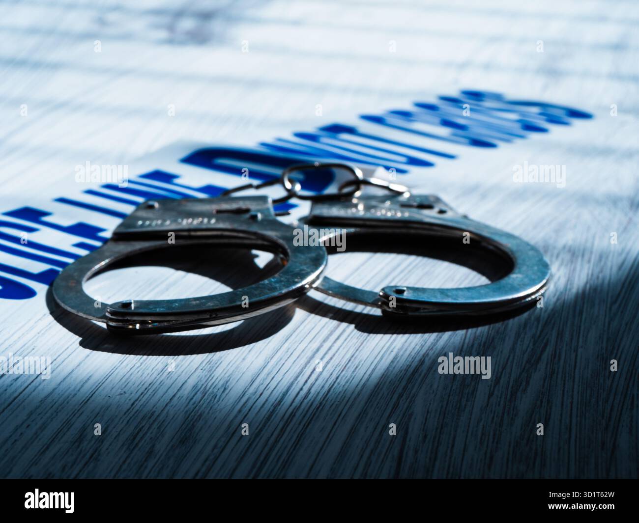 Police handcuffs on desk Stock Photo - Alamy