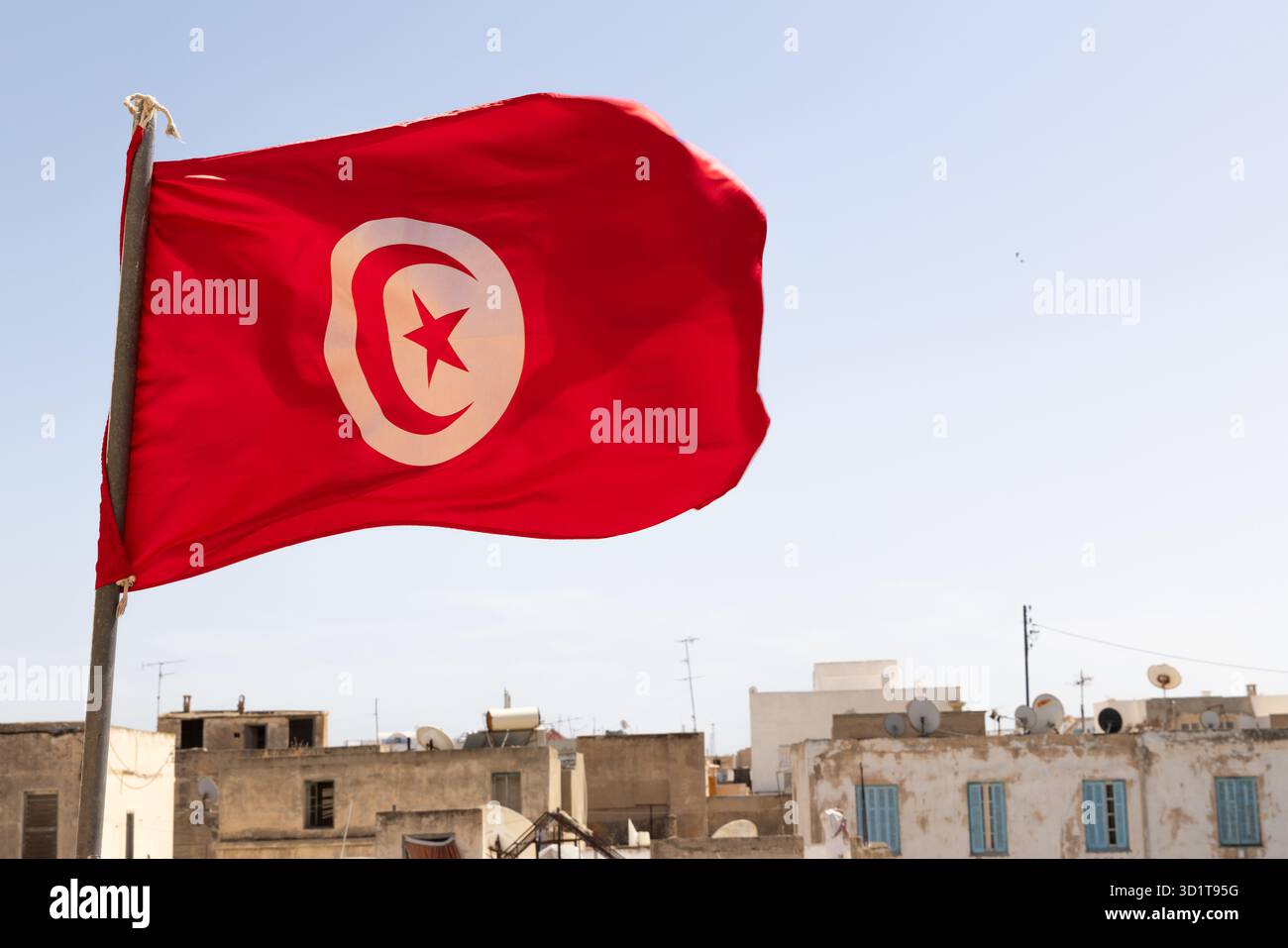 Tunisian flag waving above the rooftops of Sousse, Tunisia Stock Photo ...