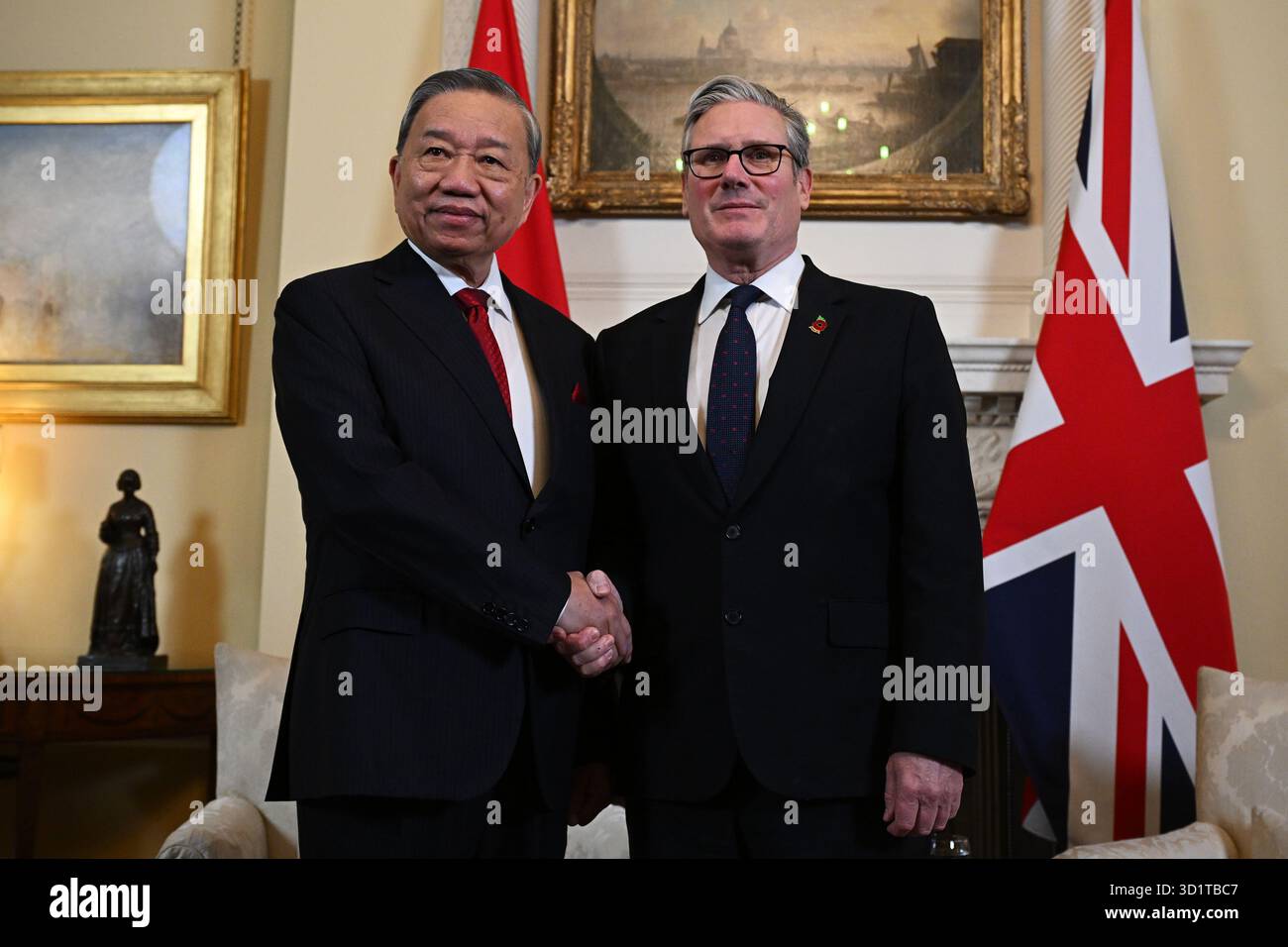 British Prime Minister Keir Starmer, right, shakes hands with General ...