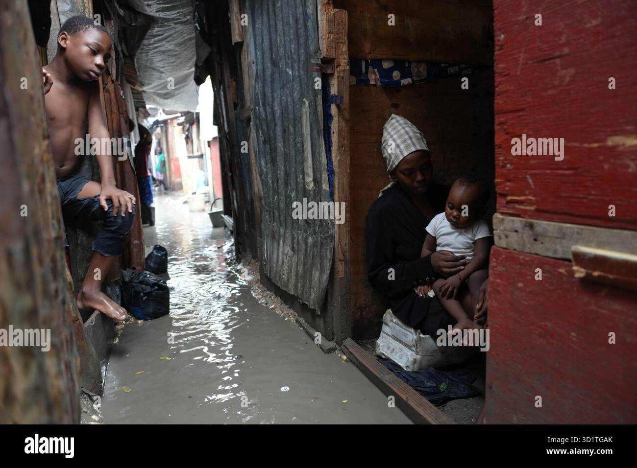 People stay inside a shelter for families displaced by gang violence ...