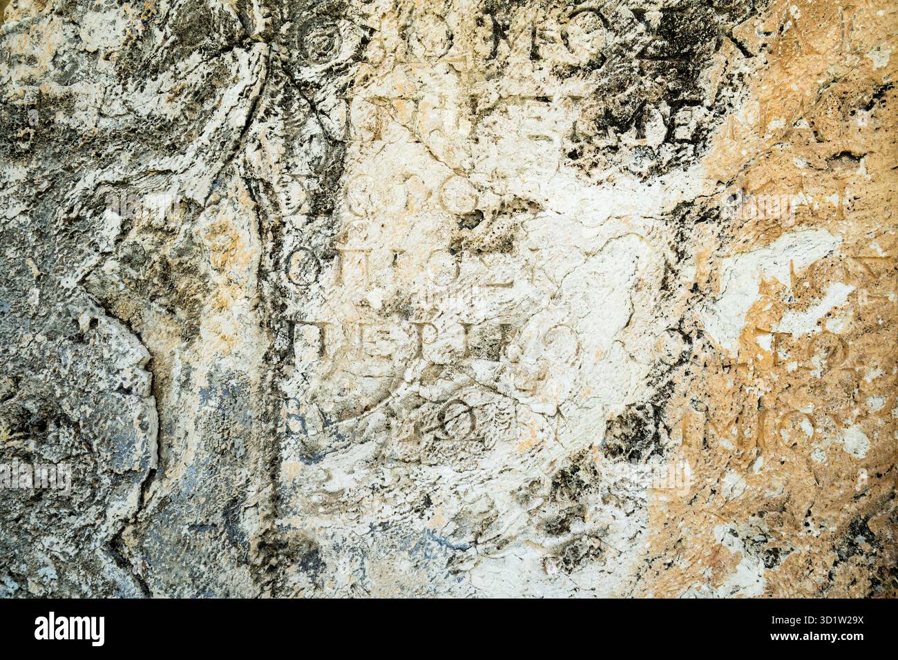 ancient stone wall texture with ancient script and slphabets. texture ...
