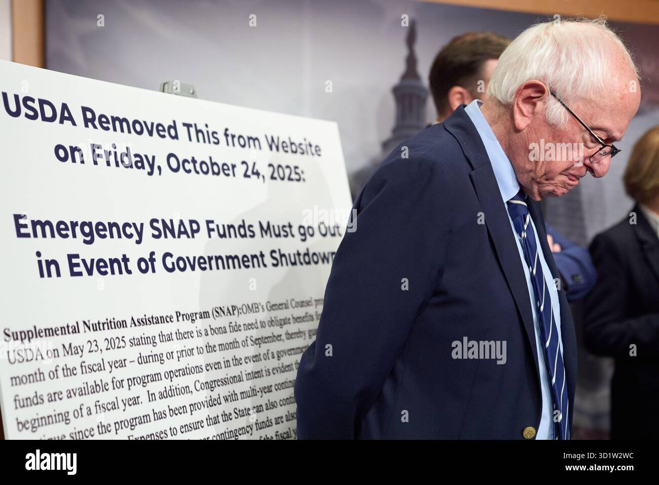 Sen. Bernie Sanders, I-Vt., stand next to a poster during a news ...